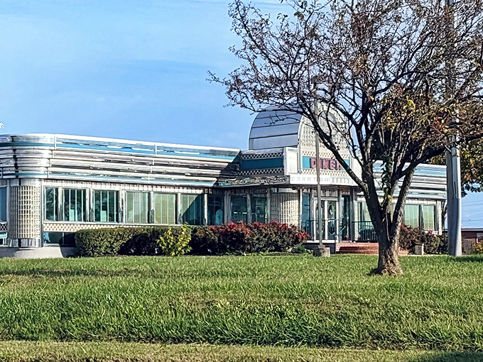 The gleaming chrome and teal facade of Boulevard Diner stands like a time machine to the golden age of roadside dining, beckoning hungry travelers with nostalgic charm.
