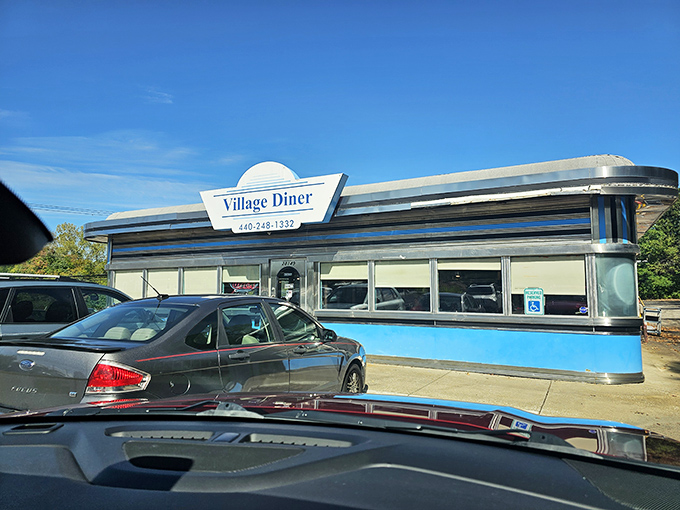 Classic Americana gleams in the Ohio sunshine. The Village Diner's chrome-and-blue exterior promises timeless comfort like a wink from the past.