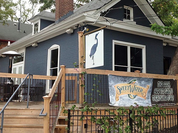 The charming blue Victorian cottage housing The Blue Heron Steakhouse stands like a culinary sentinel on Jefferson Street, its unassuming exterior hiding gastronomic treasures within.