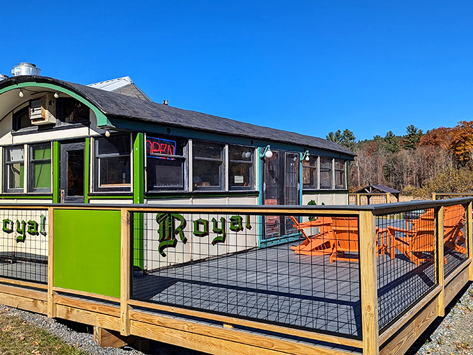 The iconic green exterior of Chelsea Royal Diner stands like a time capsule against Vermont's blue sky, complete with those inviting orange Adirondack chairs beckoning you to stay awhile.