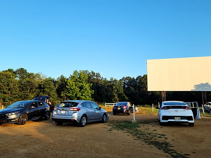 Cars lined up at twilight, waiting for cinematic magic to begin. The massive white screen stands ready against New Jersey's blue sky&mdash;a portal to another world.