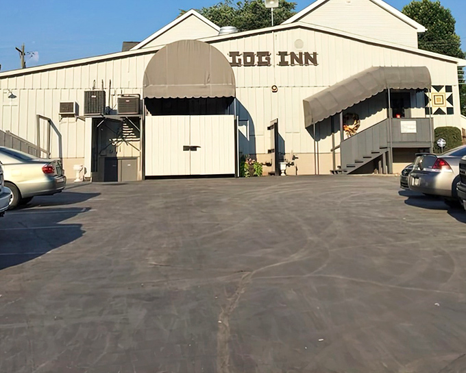 The Log Inn's parking lot at dusk &ndash; where hungry pilgrims gather for a taste of history and the Midwest's most celebrated fried chicken.