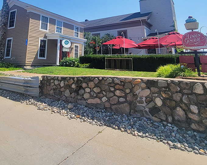 A historic church reborn as culinary heaven, complete with steeple still watching over diners. The red umbrellas add a touch of whimsy to this sacred-turned-savory space.