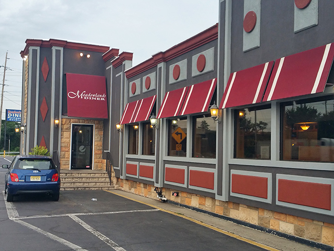 The iconic red diamond exterior of Meadowlands Diner stands like a beacon of comfort food promise in Carlstadt, where hungry souls find salvation.