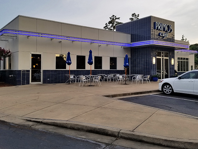 Primos Cafe's modern exterior glows with distinctive blue lighting at dusk, like a beacon calling hungry travelers home.