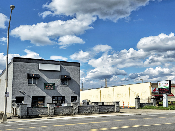 The unassuming gray fortress of flavor stands proudly on West Broad Street, where Columbus locals have been making pizza pilgrimages for decades.