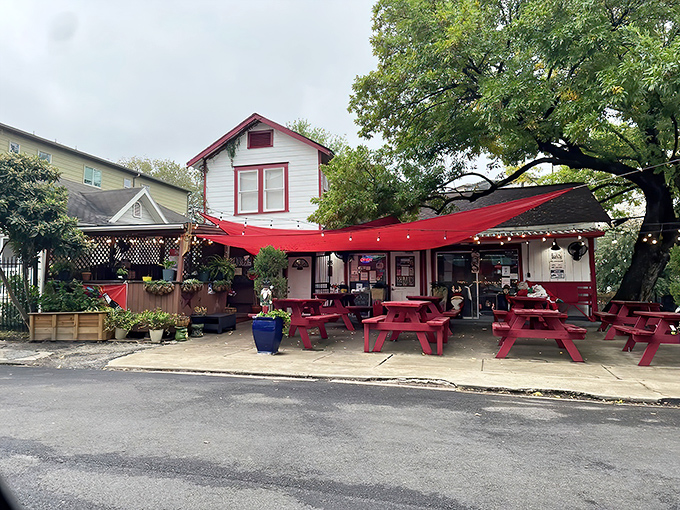 That charming white building with red trim is your beacon to burger paradise in Houston's Montrose neighborhood.