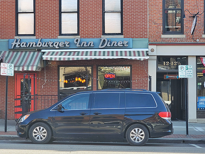 That classic neon sign beckons like an old friend, promising comfort food salvation beneath a cheerful striped awning on Winter Street.