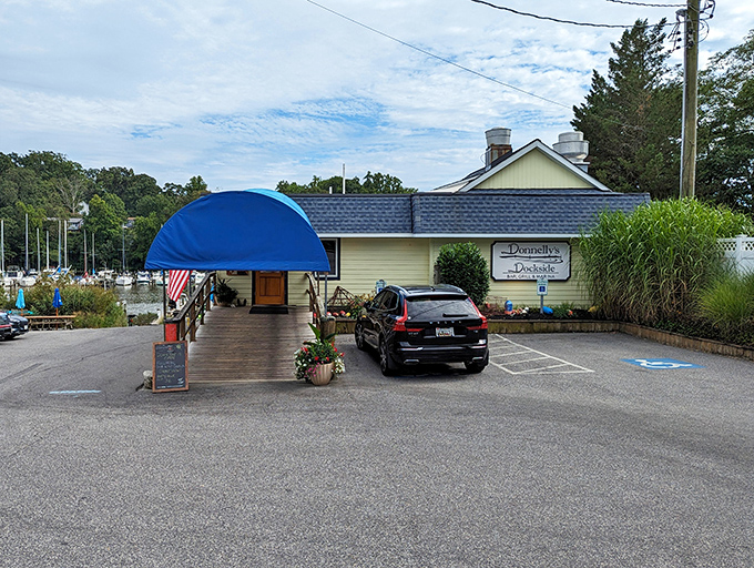 That cheerful blue umbrella marking the entrance is basically a lighthouse guiding you to crab cake paradise.