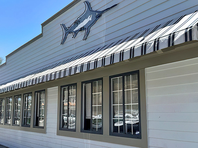 The iconic marlin silhouette announces your arrival at seafood paradise. This crisp white exterior promises maritime delights within Newport Beach's favorite seafood destination.