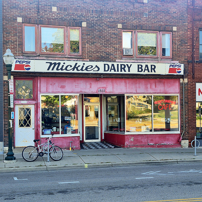 The iconic pink facade of Mickey's Dairy Bar stands as a Madison landmark, beckoning hungry visitors with its vintage Pepsi sign and timeless charm.
