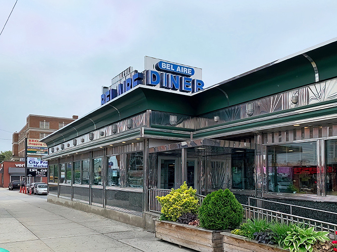 The gleaming chrome exterior of Bel Aire Diner stands as an Astoria landmark, its vintage sign beckoning hungry New Yorkers like a neon North Star for comfort food pilgrims.
