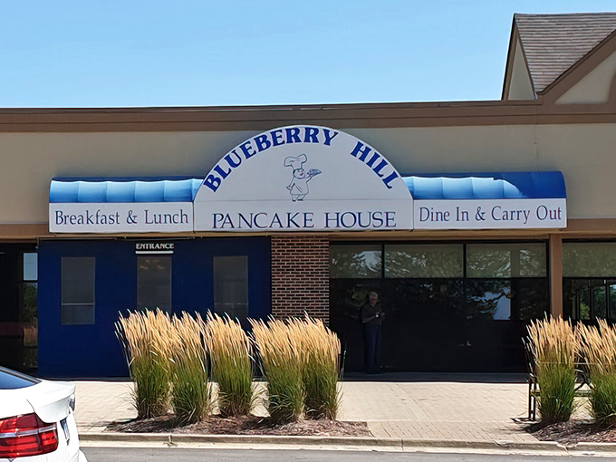 Morning sunshine highlights the cheerful exterior where ornamental grasses wave hello, as if nature itself is excited about the pancakes inside.
