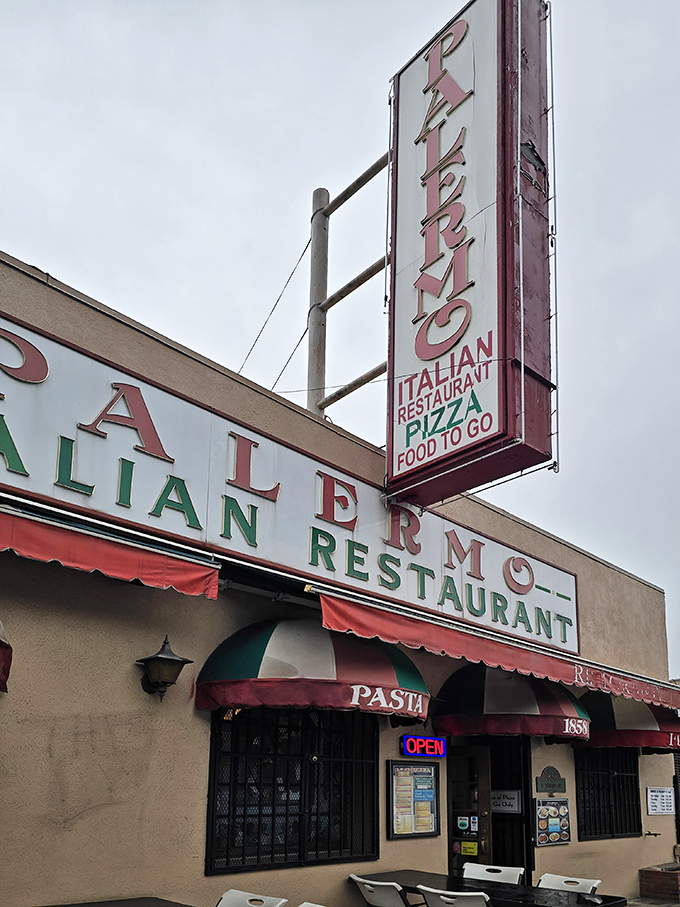 The iconic vertical sign beckons like an old friend, promising Italian comfort in a city obsessed with the next culinary trend.