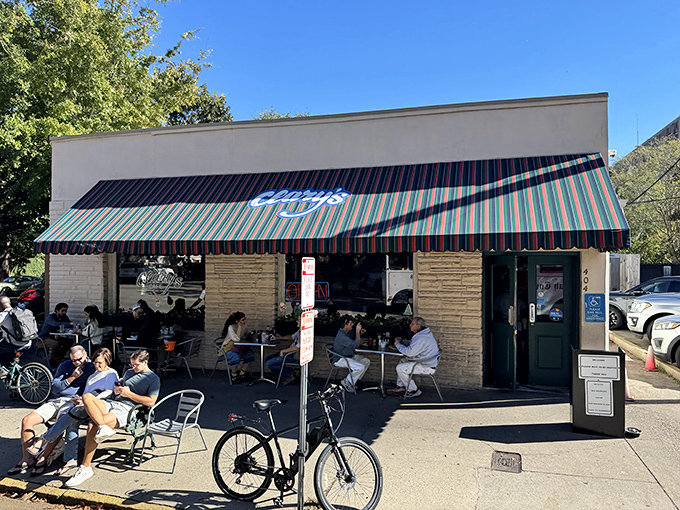 The iconic striped awning of Clary's Cafe stands as a beacon of breakfast hope on Abercorn Street, promising Southern comfort in every bite.