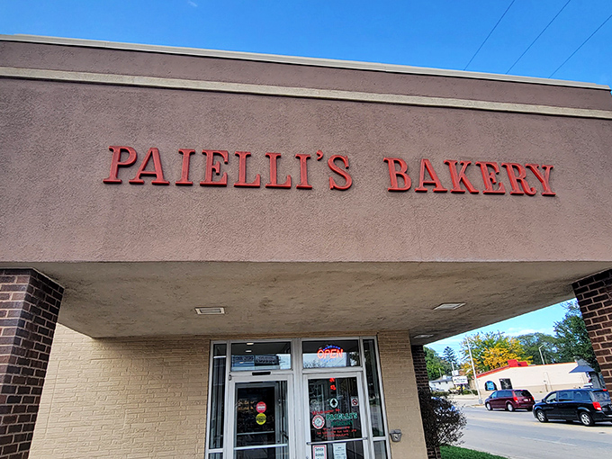 That pink signage against the brick isn't shouting for attention—it's confidently whispering that something extraordinary awaits inside.