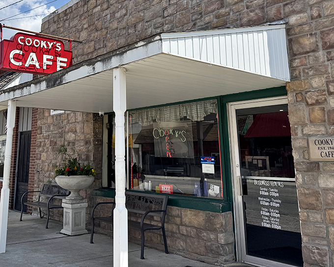 The iconic red sign of Cooky's Cafe stands out against the rustic stone facade, beckoning hungry travelers like a culinary lighthouse in Golden City.