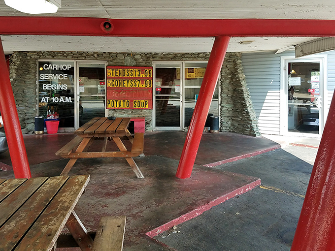 The iconic red-beamed entrance to Ray's Drive-In beckons like a time portal to simpler days when car hops and comfort food reigned supreme.