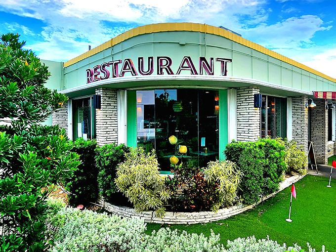 The mint-green exterior of Howley's stands as a mid-century modern beacon on South Dixie Highway, promising comfort food with a side of nostalgia.