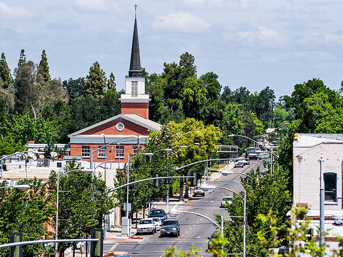 Church steeples and tree-lined streets define Visalia's small-town character, where neighbors still wave and parking doesn't require a second mortgage.