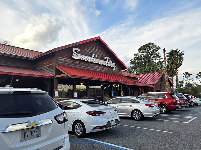 The quintessential Southern BBQ joint beckons with its rustic charm and red metal roof &ndash; a carnivore's cathedral where diet plans go to die.