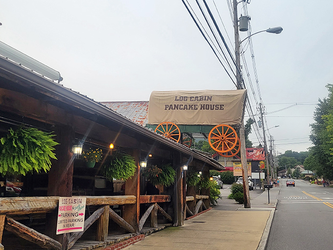 The iconic covered wagon sign beckons hungry travelers like a breakfast lighthouse guiding ships to shore. Rustic charm that promises mountain hospitality awaits.