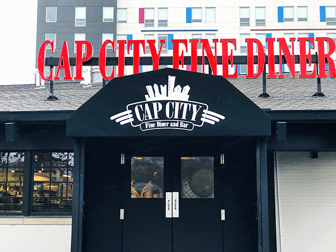 The bold red lettering of Cap City Fine Diner beckons like a neon promise of comfort food nirvana. Classic diner aesthetics with an upscale twist.