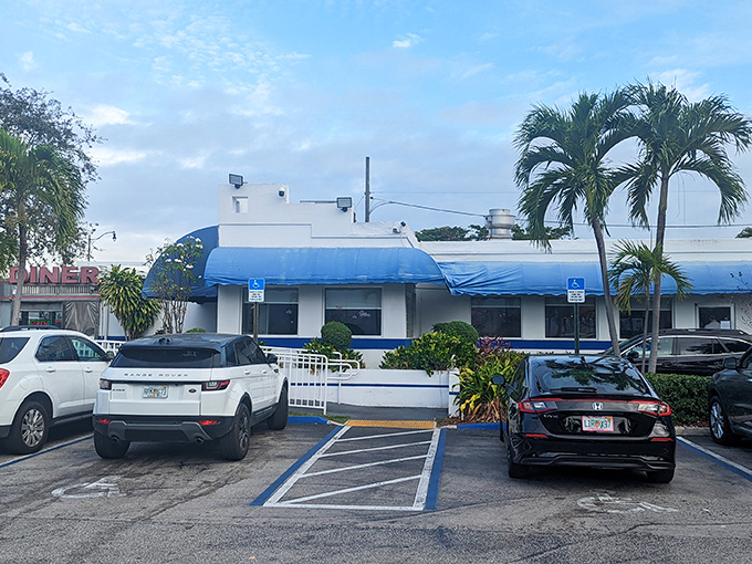 The gleaming stainless steel exterior of Jack's Hollywood Diner catches Florida sunshine like a time machine that happens to serve breakfast. Classic Americana at its finest.