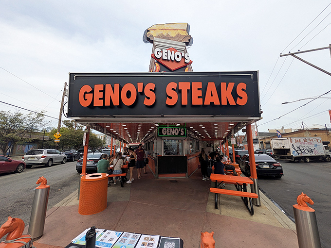 The neon-lit kingdom of Geno's Steaks stands proudly at the corner of 9th and Passyunk, a fluorescent orange beacon calling hungry pilgrims to Philadelphia's cheesesteak mecca.
