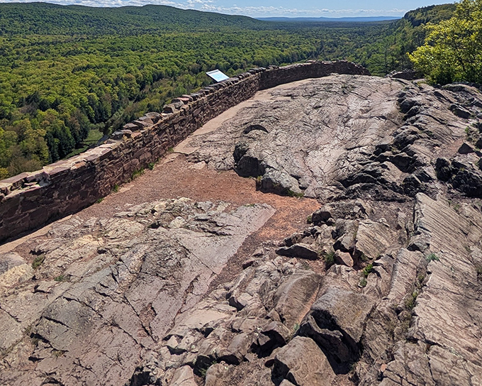 Nature's balcony: The stone wall of the Lake of the Clouds Overlook frames the endless carpet of green forest and serpentine blue waters below.
