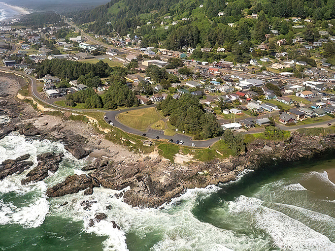 From an aerial view, Yachats’ shoreline showcases the meeting of forest and sea, providing a serene backdrop for reflection, with weathered driftwood hinting at the ocean’s stories.