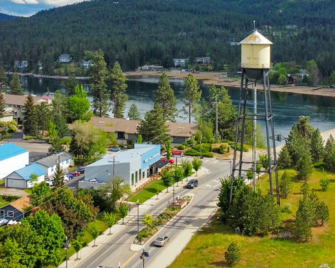 The iconic yellow water tower stands sentinel over Post Falls, where small-town charm meets riverfront splendor in perfect Idaho harmony.