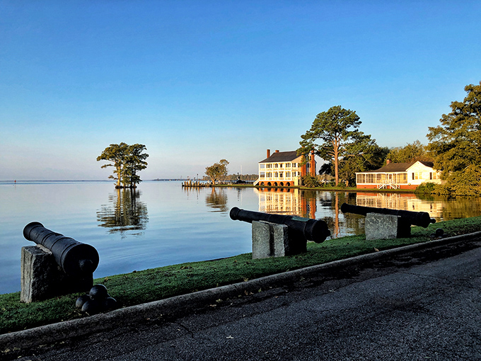 Morning tranquility at Edenton's waterfront, where historic cannons stand guard over waters so calm they look Photoshopped. Nature's screensaver comes to life.
