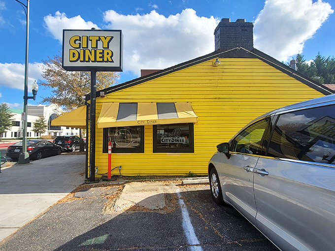 Morning light bathes City Diner's cheerful yellow facade, proving that sometimes the best things in life come in buildings the color of perfectly scrambled eggs.