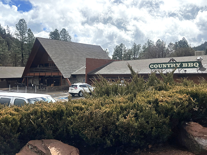 The A-frame entrance to Zane Grey Country BBQ stands like a rustic gateway to flavor paradise, nestled among Payson's majestic pines.