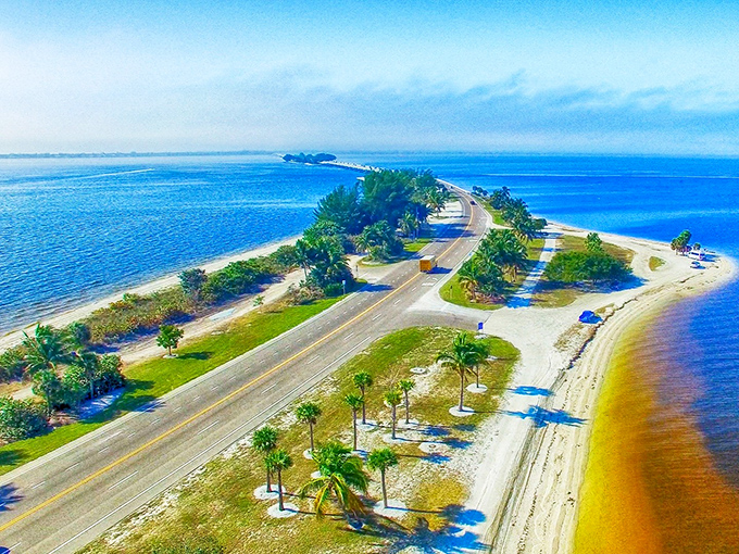 Nature's perfect highway doesn't exist? Tell that to this sun-drenched causeway where palm trees stand guard and turquoise waters beckon from both sides.