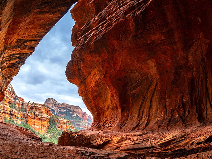 Nature's grand cathedral awaits. This stunning rock formation frames a view that makes you question why you ever waste time scrolling through social media.
