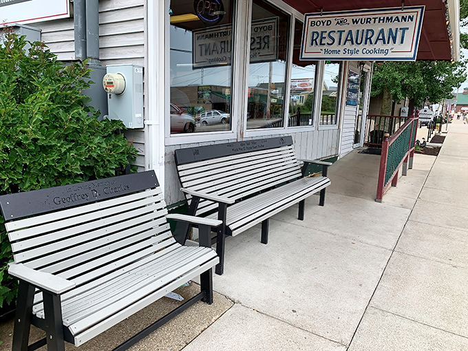 The classic storefront beckons with wooden benches where locals swap stories while waiting for their slice of homemade heaven.