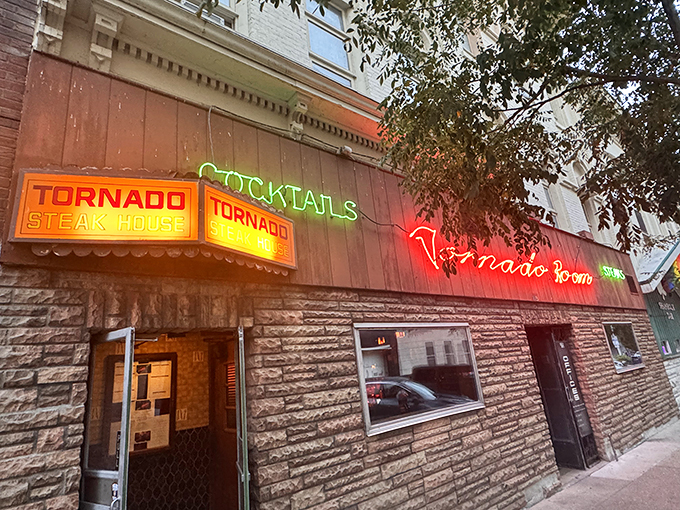 The neon glow of Tornado Steak House beckons carnivores like a lighthouse for the gloriously hungry.