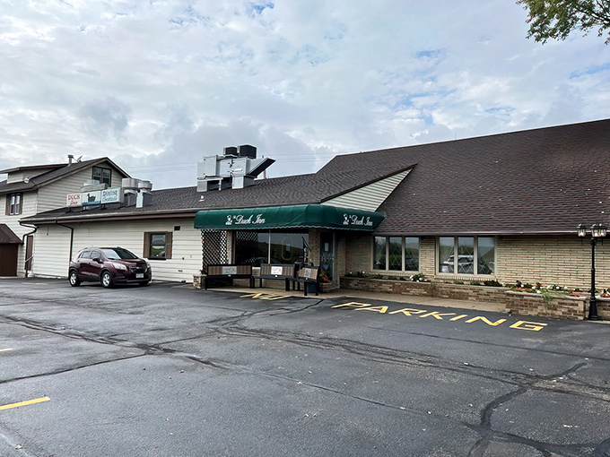 The unassuming exterior hides culinary treasures within, like finding a secret speakeasy in Wisconsin's countryside. Green awnings welcome hungry travelers.