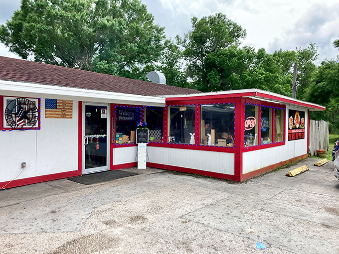 The humble red-trimmed exterior of The Red Top Pit Stop stands like a beacon for BBQ pilgrims, promising smoky delights within its unassuming walls.