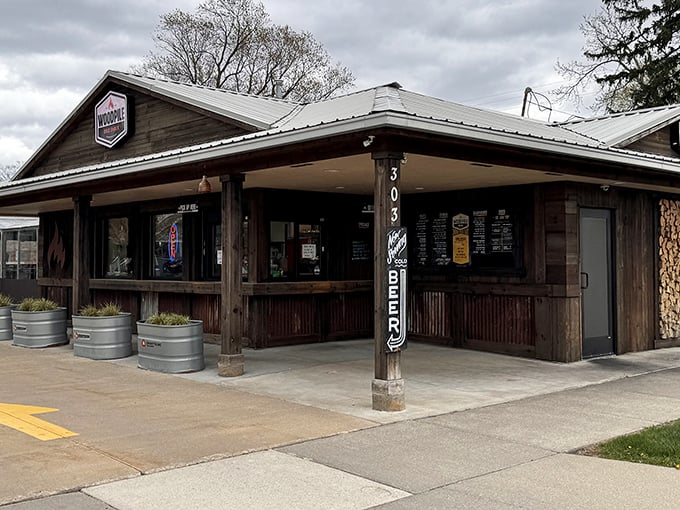 A quintessential BBQ joint facade that whispers, "The calories don't count if the food's this good." Those metal planters aren't just for show.
