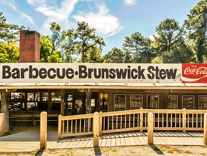 The weathered sign and rustic wooden exterior aren't putting on airs – they're promising authentic barbecue magic that's been perfected over decades.