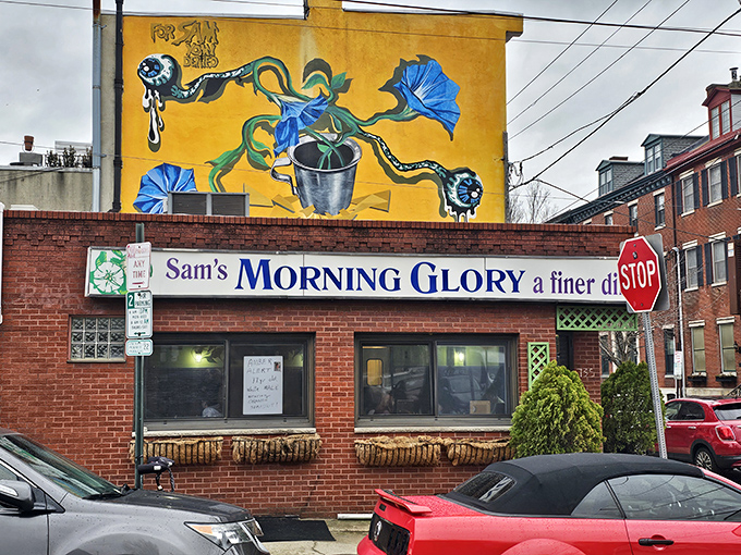 The bright yellow mural of morning glories above this brick facade isn't just art&mdash;it's a promise of the colorful culinary experience waiting inside.