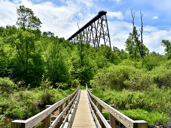 A wooden boardwalk leads to engineering marvel—like finding the yellow brick road that ends with a colossal steel giant instead of an emerald city.