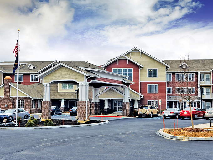 The welcoming facade of Sterling Heights combines warm reds and yellows with a covered entrance that says "come in from the Pennsylvania rain" without saying a word.