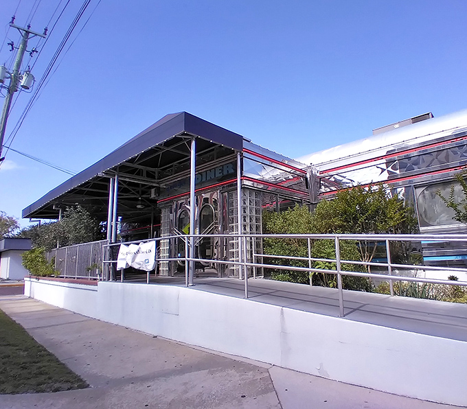 The gleaming chrome exterior of Georgie's Diner shines like a beacon of breakfast hope, complete with classic glass blocks and that unmistakable retro silhouette.