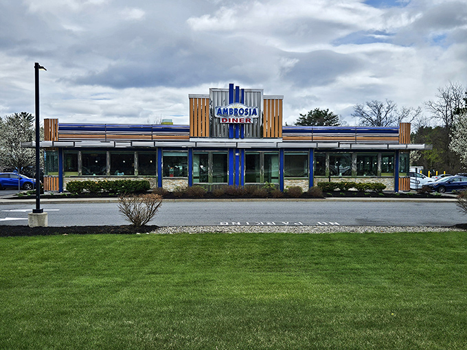 The gleaming Art Deco façade of Ambrosia Diner stands like a time machine in Queensbury, promising comfort food that transcends eras and satisfies souls.