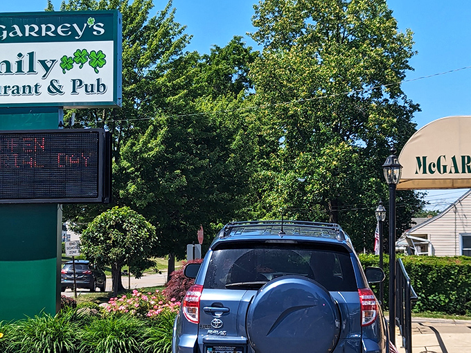 McGarrey's exterior sign stands proudly among lush greenery, a beacon for hungry travelers seeking refuge from chain restaurant monotony.