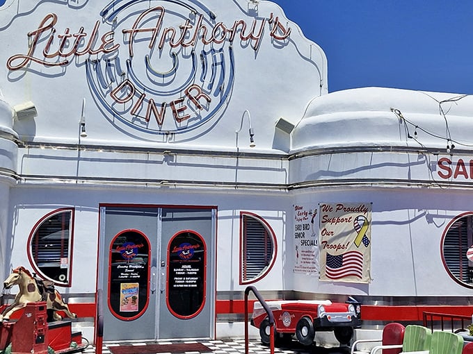 The gleaming white exterior of Little Anthony's Diner stands out against Tucson's blue sky like a time machine disguised as a building.